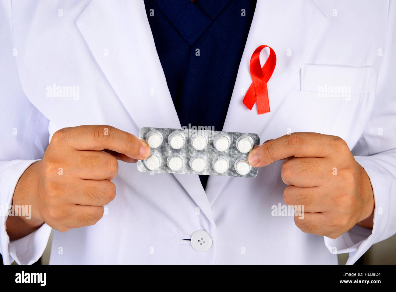 Doctor hand holding cure for AIDS. AIDS cure concept Stock Photo - Alamy