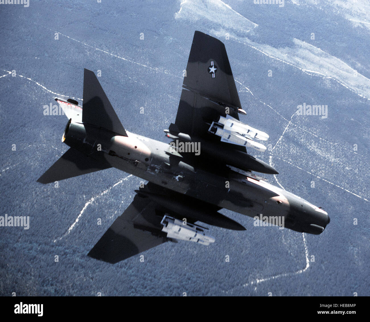 An air-to-air underside view of an A-7D Corsair II aircraft banking to ...