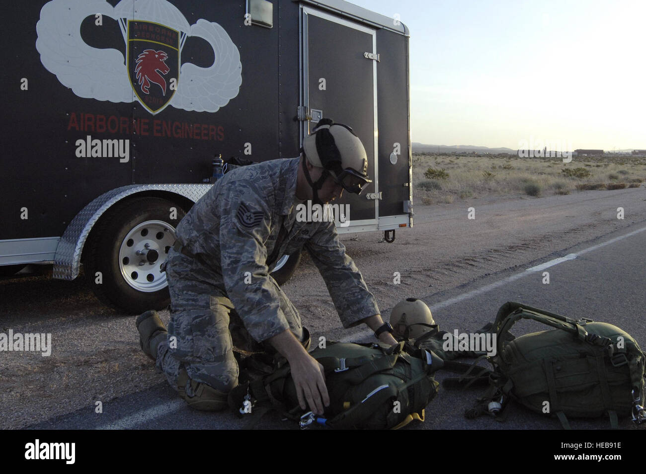 Tech. Sgt. Joshua Tully lays out and performs a pre-jump inspection on ...
