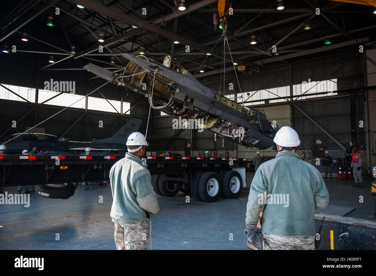 Airmen from the 8th Maintenance Squadron guide a damaged F-16 onto a ...