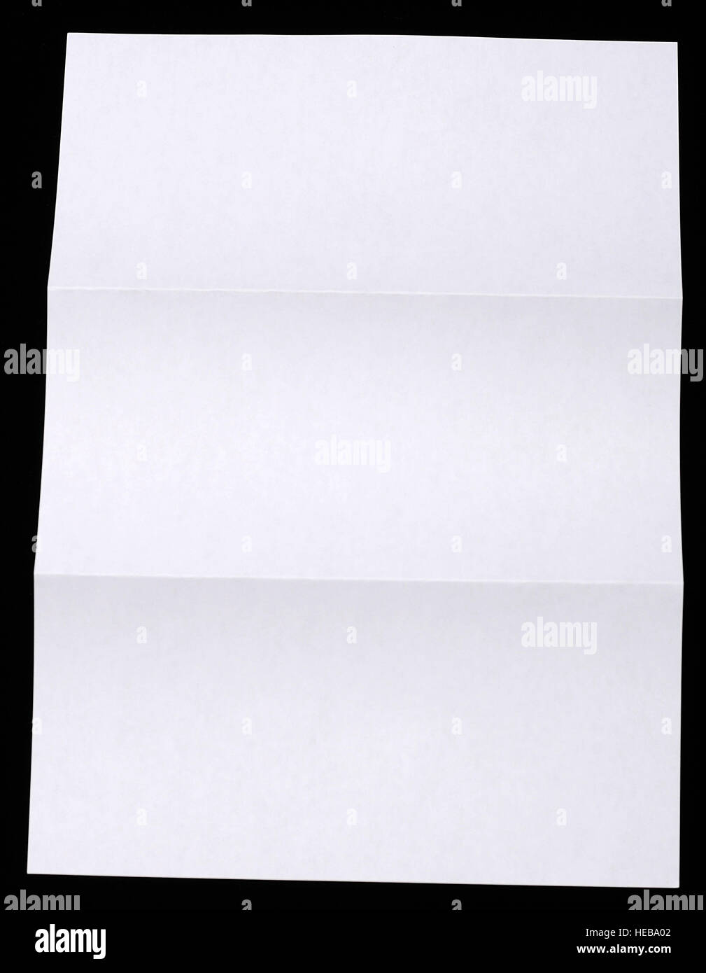 Sheet of paper folded onver black background Stock Photo - Alamy