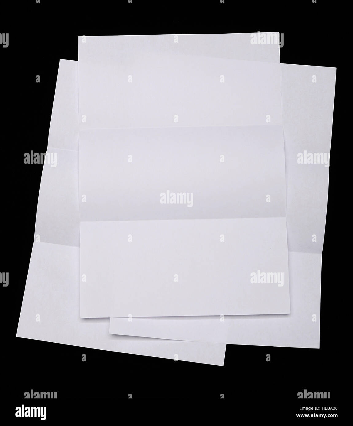 Sheet of paper folded onver black background Stock Photo - Alamy