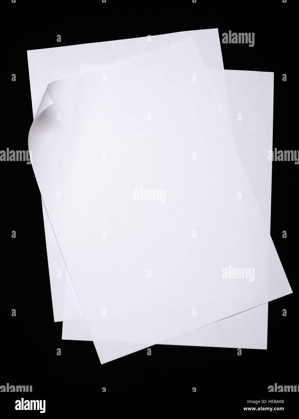 Sheet of paper folded onver black background Stock Photo - Alamy