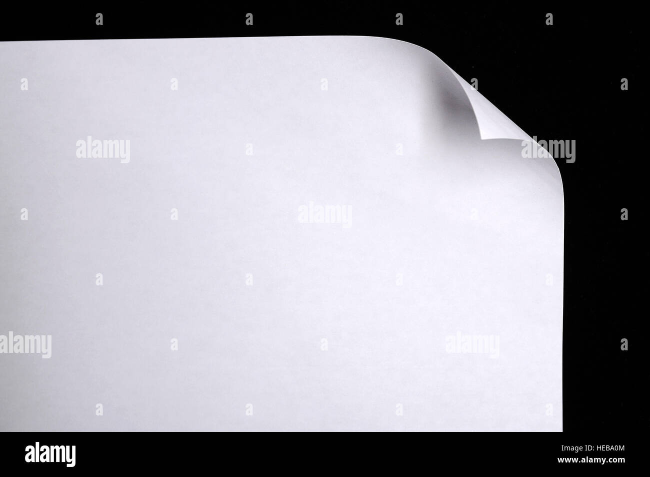 Sheet of paper folded onver black background Stock Photo - Alamy
