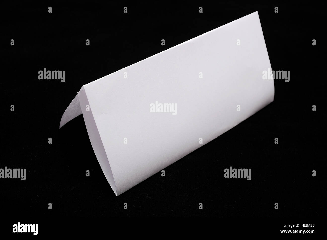 Folded paper isolated over black background. You can put your design on ...