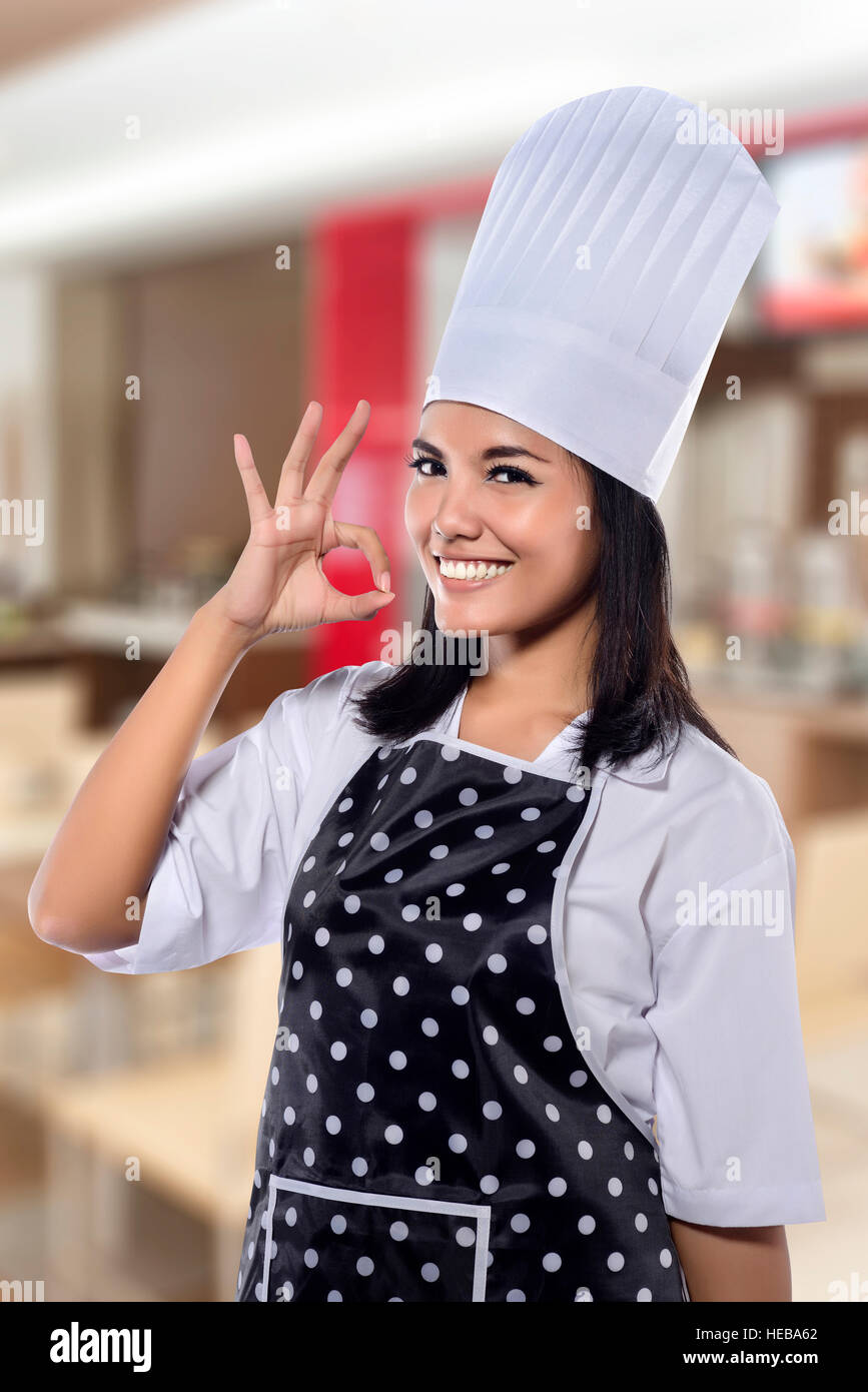 Portrait of beautiful pretty woman chef with restaurant background ...