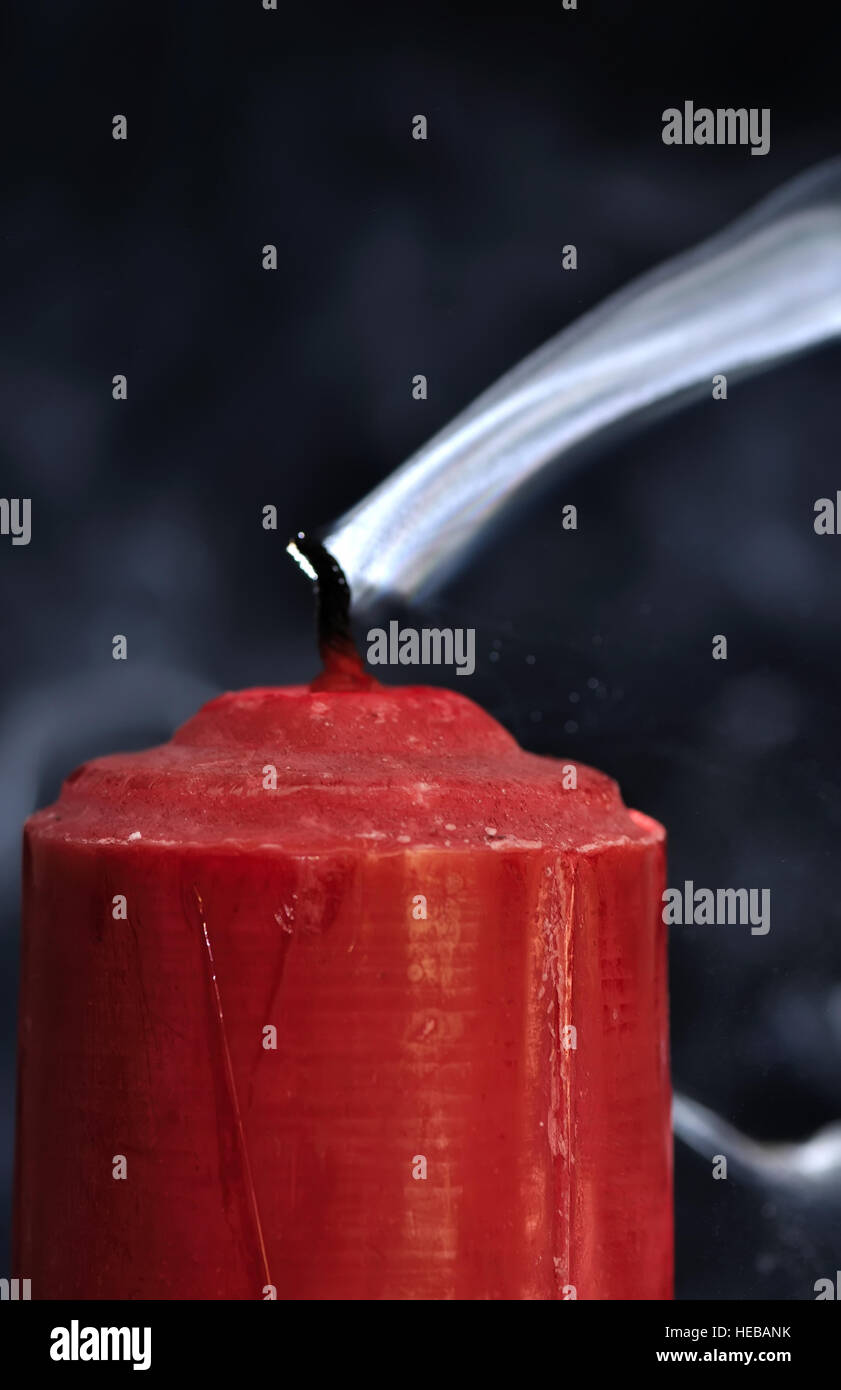 Red extinguished red candles on black background Stock Photo - Alamy