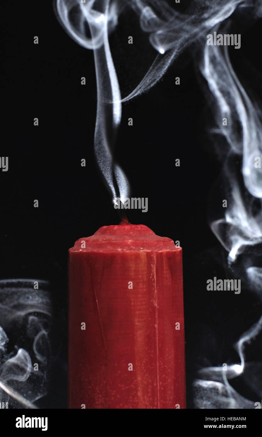 Red extinguished red candles on black background Stock Photo - Alamy
