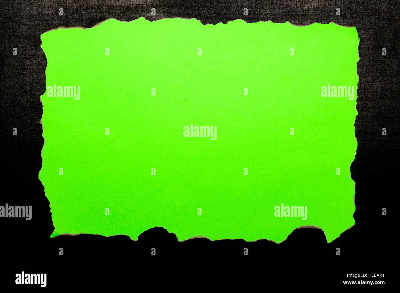Green burnt paper on chalkboard. You can put your design on the paper ...