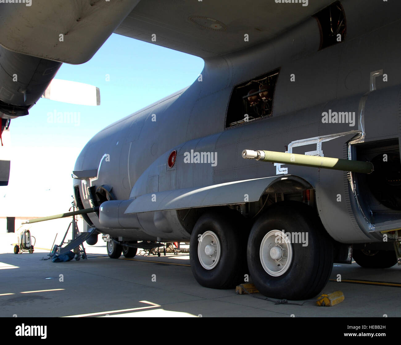 Bushmaster 30 mm cannons protrude from the gunports of an AC-130U ...