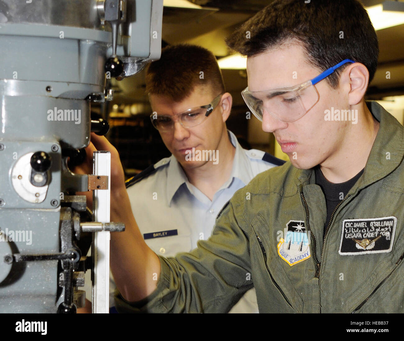 Maj. Douglas Bayley assists Cadet 1st Class Daniel O'Sullivan with a ...