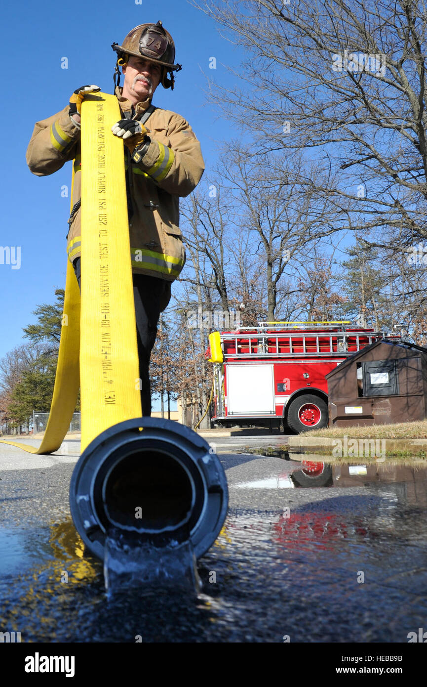 Mr. Jay Thomas, 11 Civil Engineer Squadron, crew chief drains the water ...