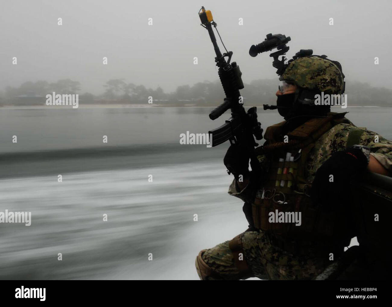 U.S. Navy member conducts boat patrols during Emerald Warrior near ...