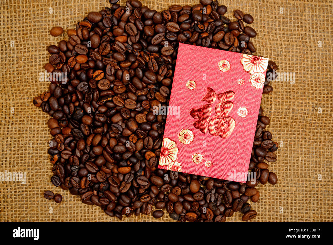 Chinese ang pao and coffee bean over burlap background Stock Photo - Alamy