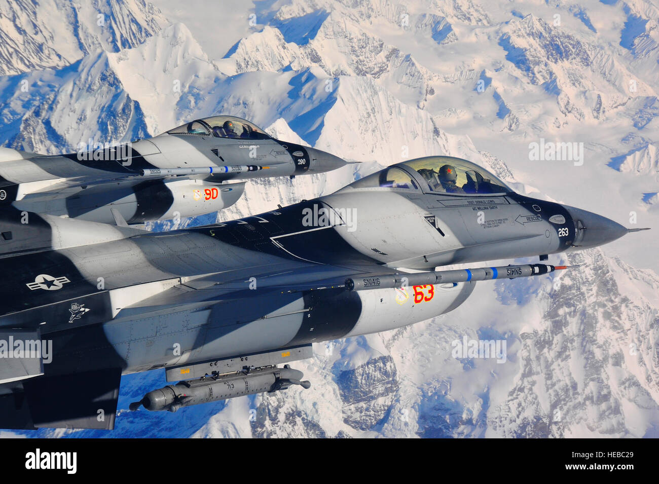A pair of F-16 Fighting Falcon Aggressors fly over the Alaska Range ...