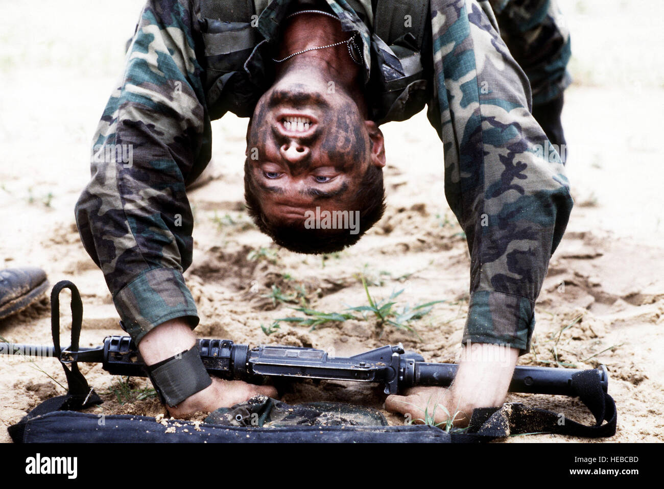 Combat Control School student, holding a XM-117 submachine gun, is ...