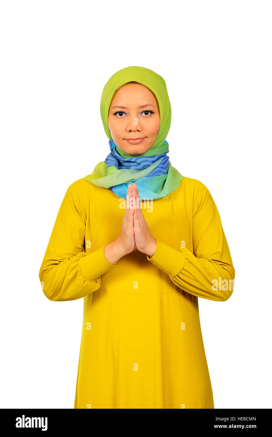Young beautiful moslem woman greeting isolated on white background ...