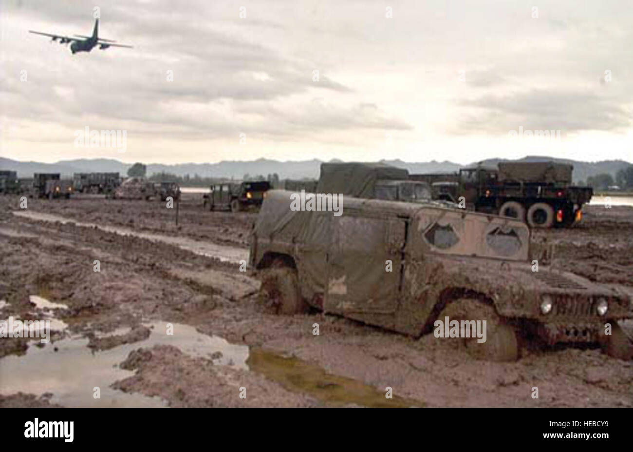 enw24bombarmy4 1999 Stars and Stripes A Humvee mired in the mud at Task ...
