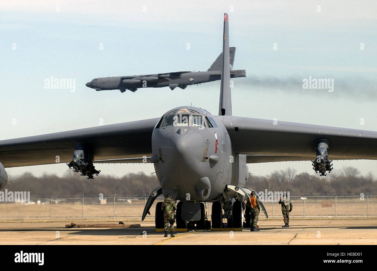 A B-52 prepares for departure as another B-52 arrives. The B-52 is ...