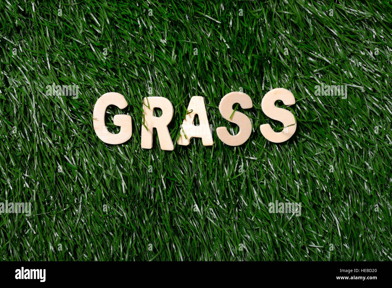 Grass wooden sign on green grass background Stock Photo - Alamy