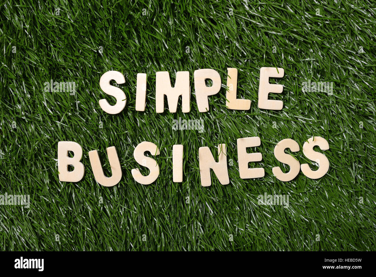 Simple business wooden sign on green grass background Stock Photo - Alamy