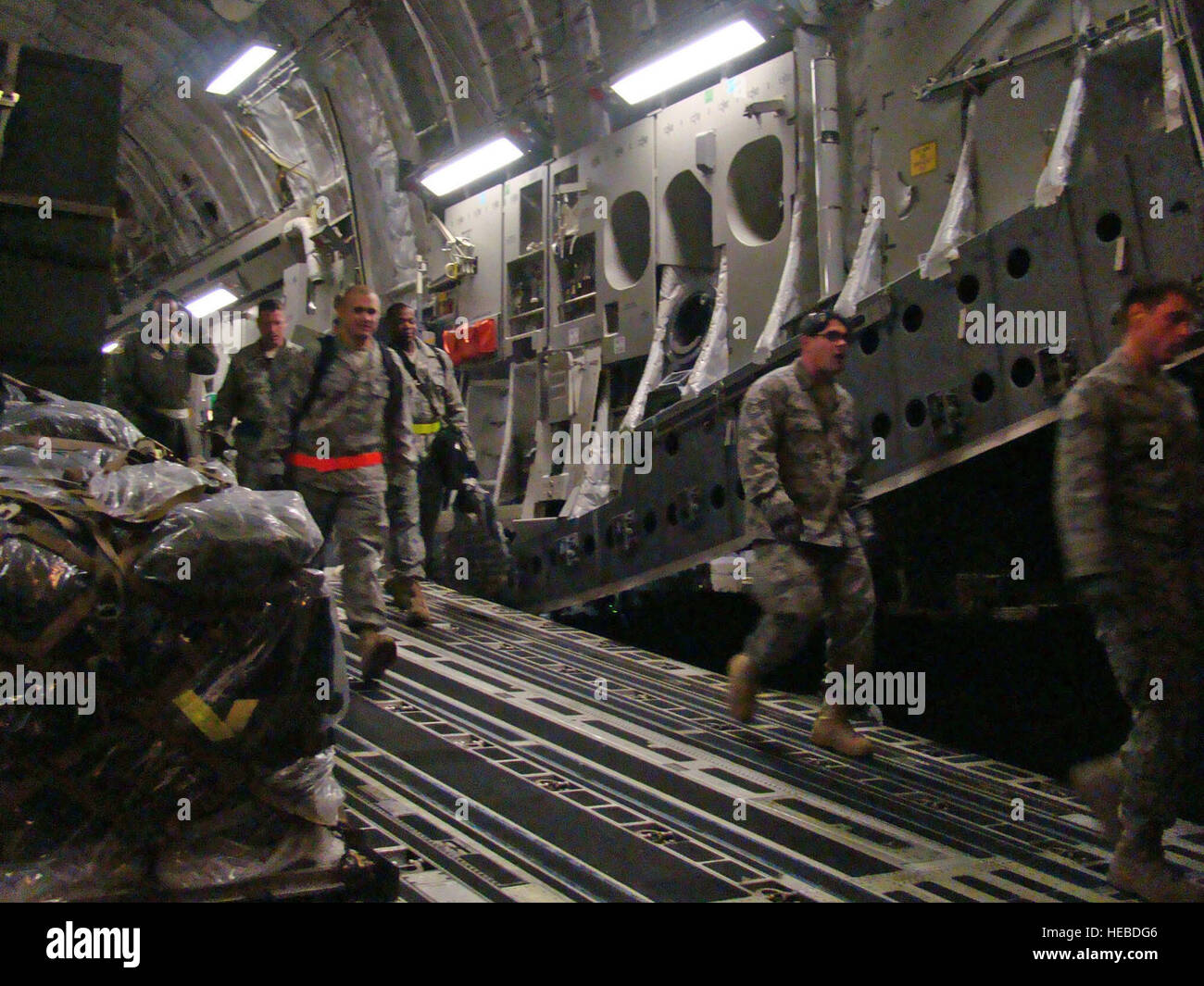 Members of the 621st Contingency Response Wing step down a C-17 ...