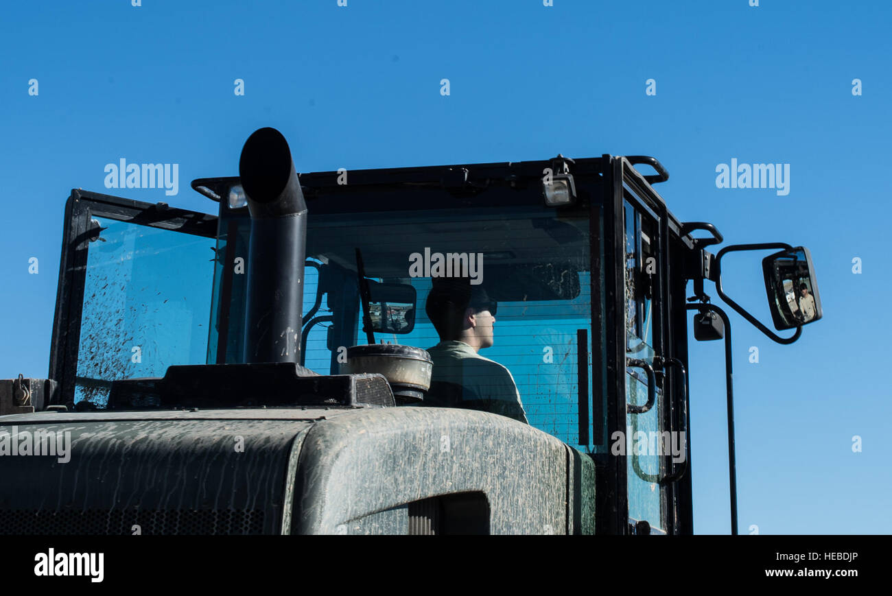 A U.S. Air Force aerial port Airman uses a fork lift to move bundled ...