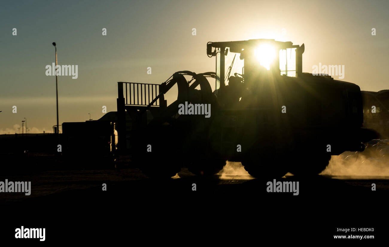 A U.S. Air Force aerial port Airman uses a fork lift to move bundled ...