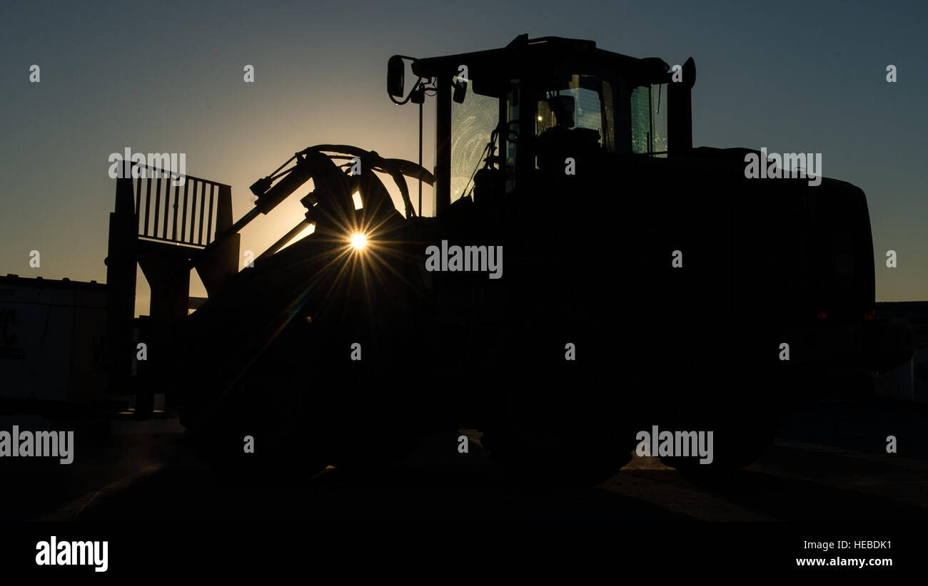 A U.S. Air Force aerial port Airman uses a fork lift to move bundled ...