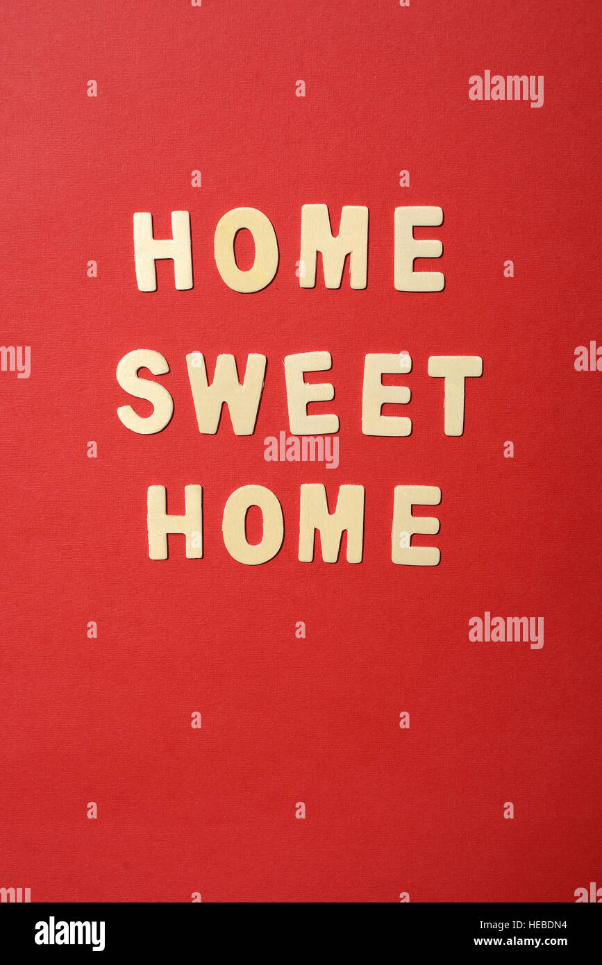 Home sweet home text on red paper backbround Stock Photo - Alamy