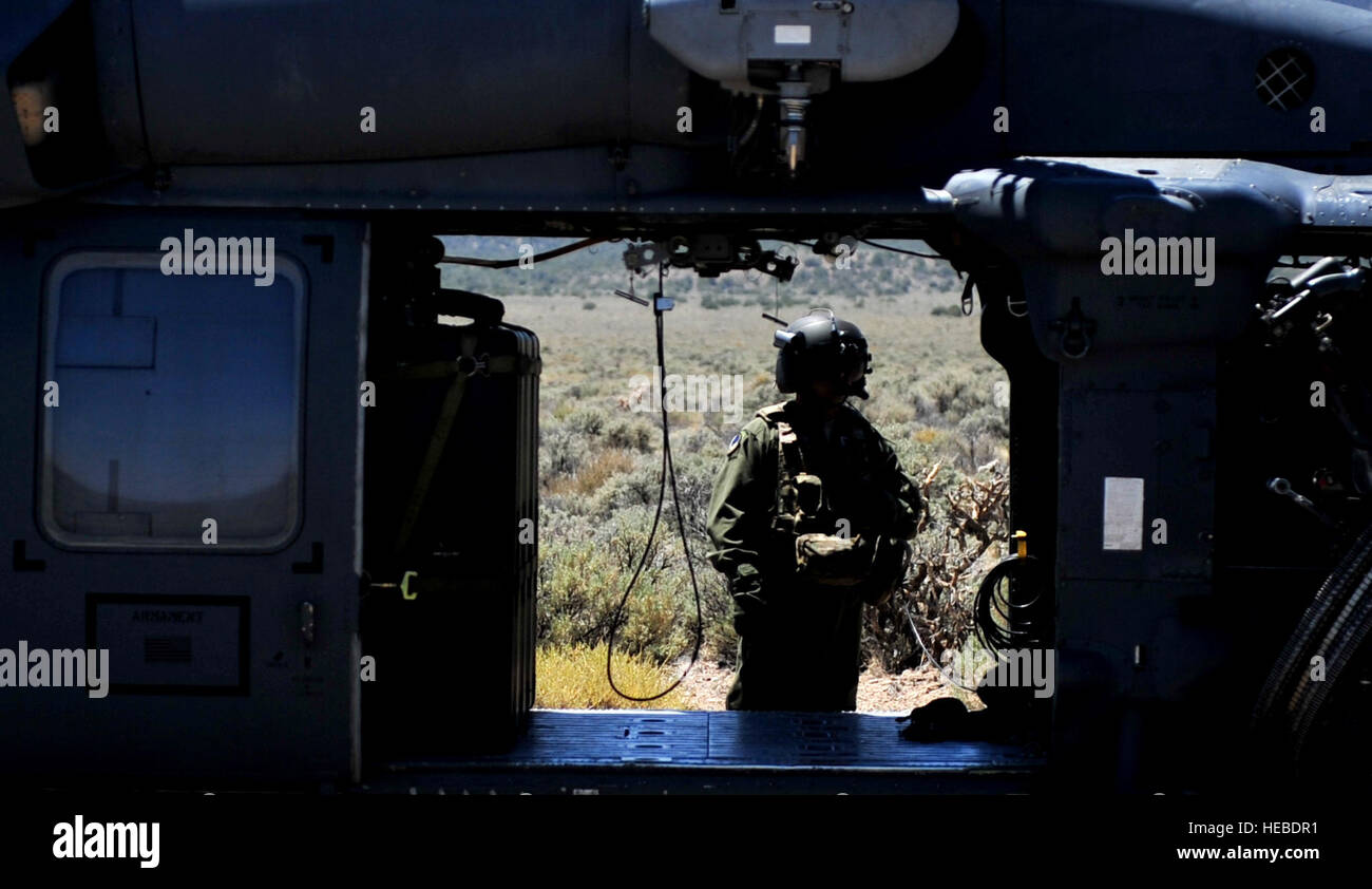 A U.S. Air Force HH-60 Pave Hawk flight engineer prepares the ...