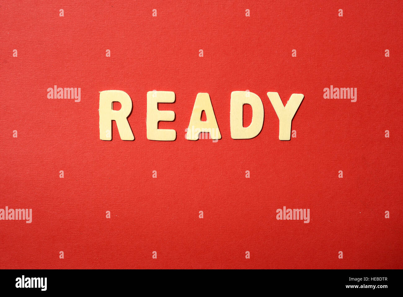 Ready text on red paper backbround Stock Photo - Alamy
