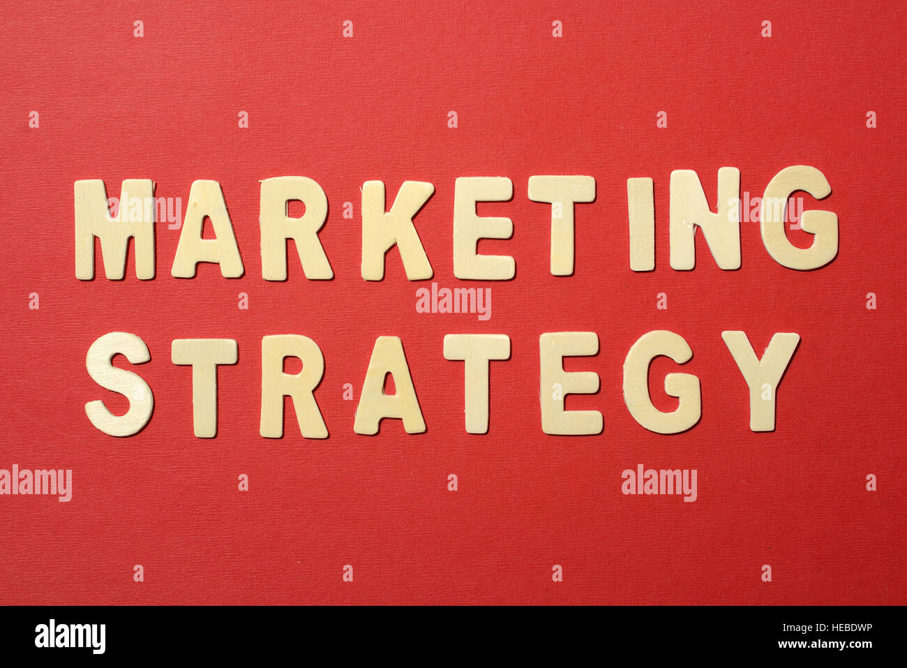 Marketing Strategy text on red paper backbround Stock Photo - Alamy