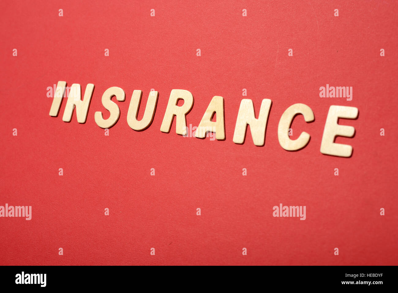 Insurance text on red paper backbround Stock Photo - Alamy