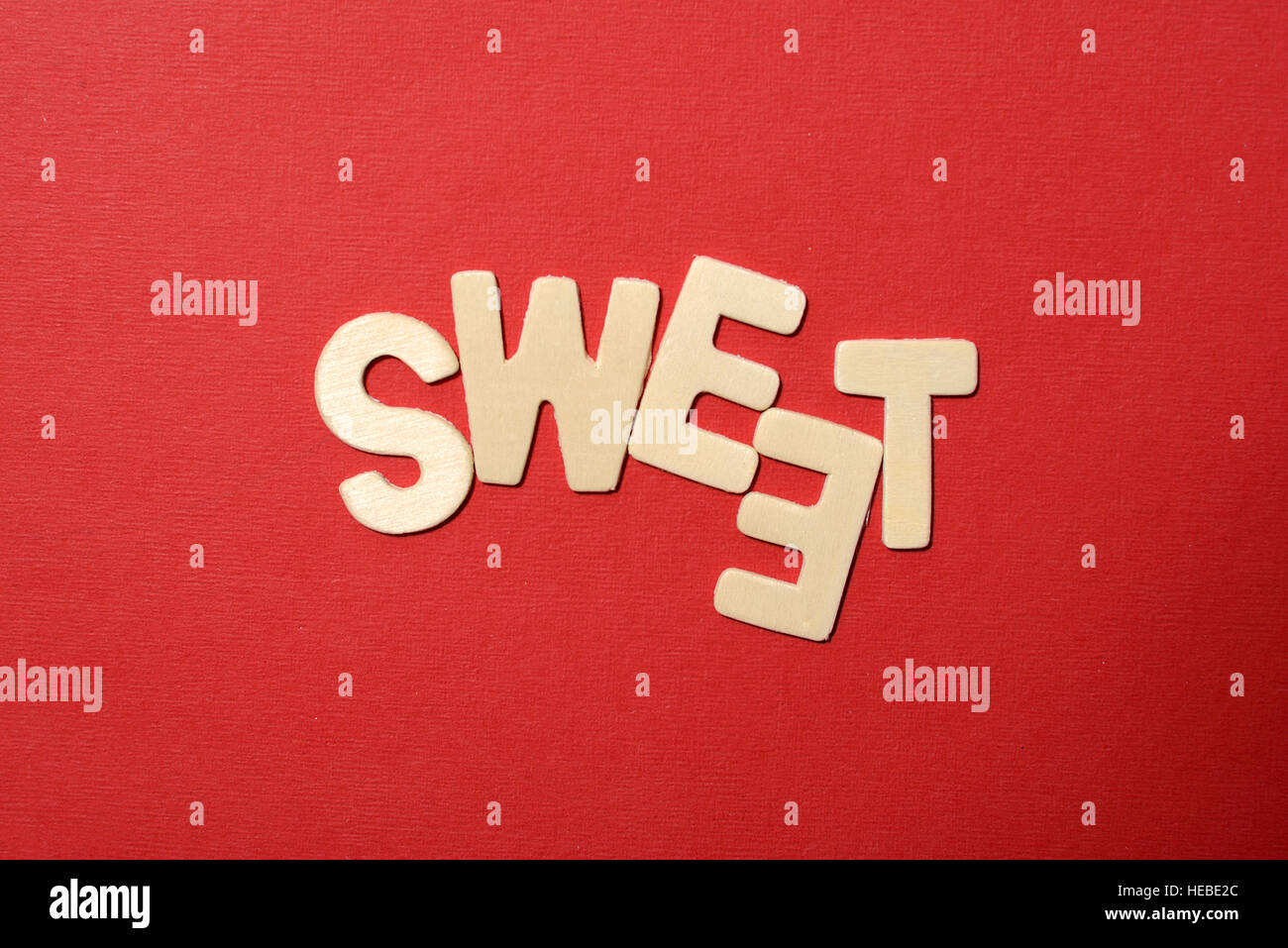 Sweet text on red paper backbround Stock Photo - Alamy