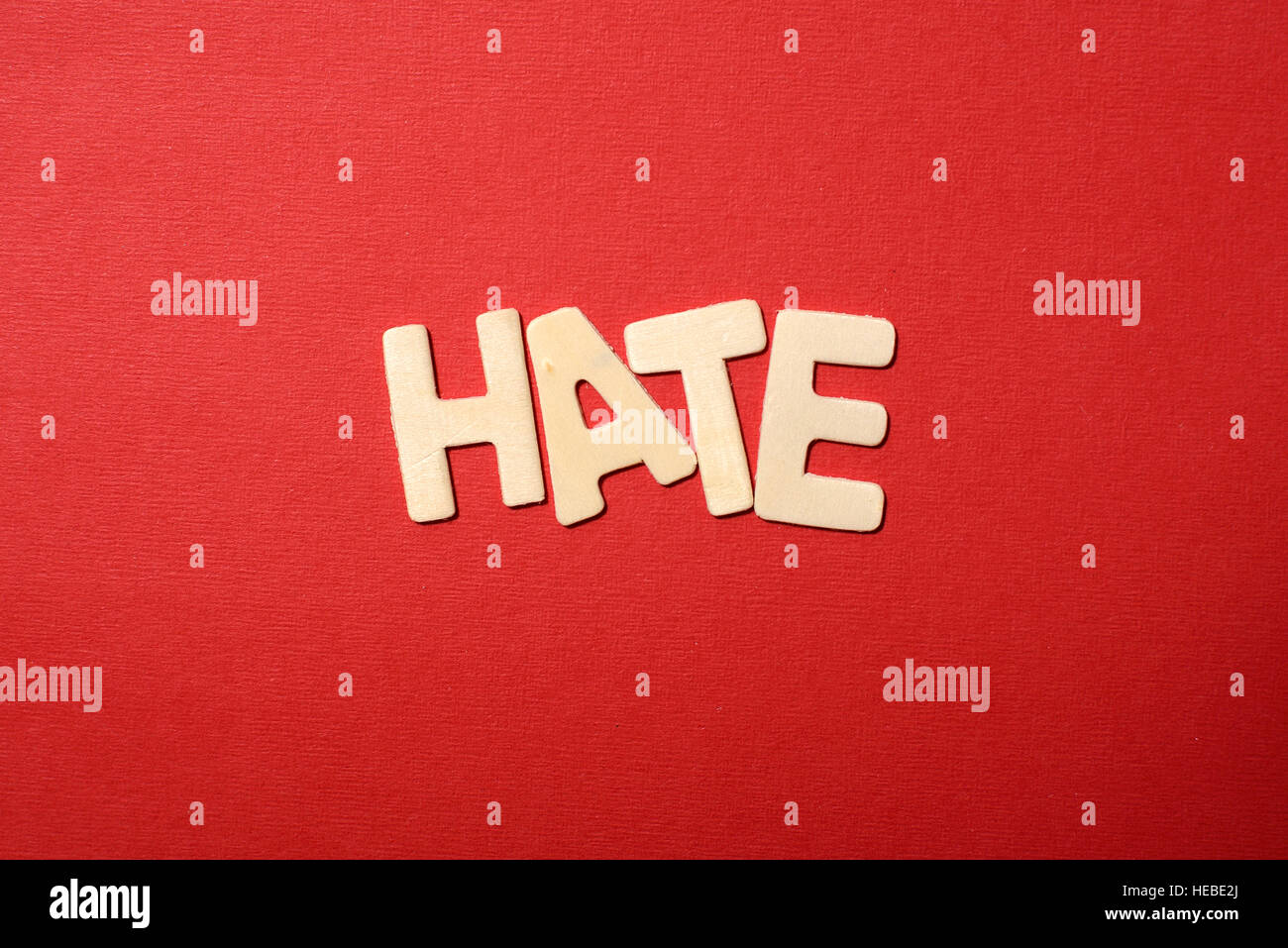 Hate text on red paper background Stock Photo - Alamy