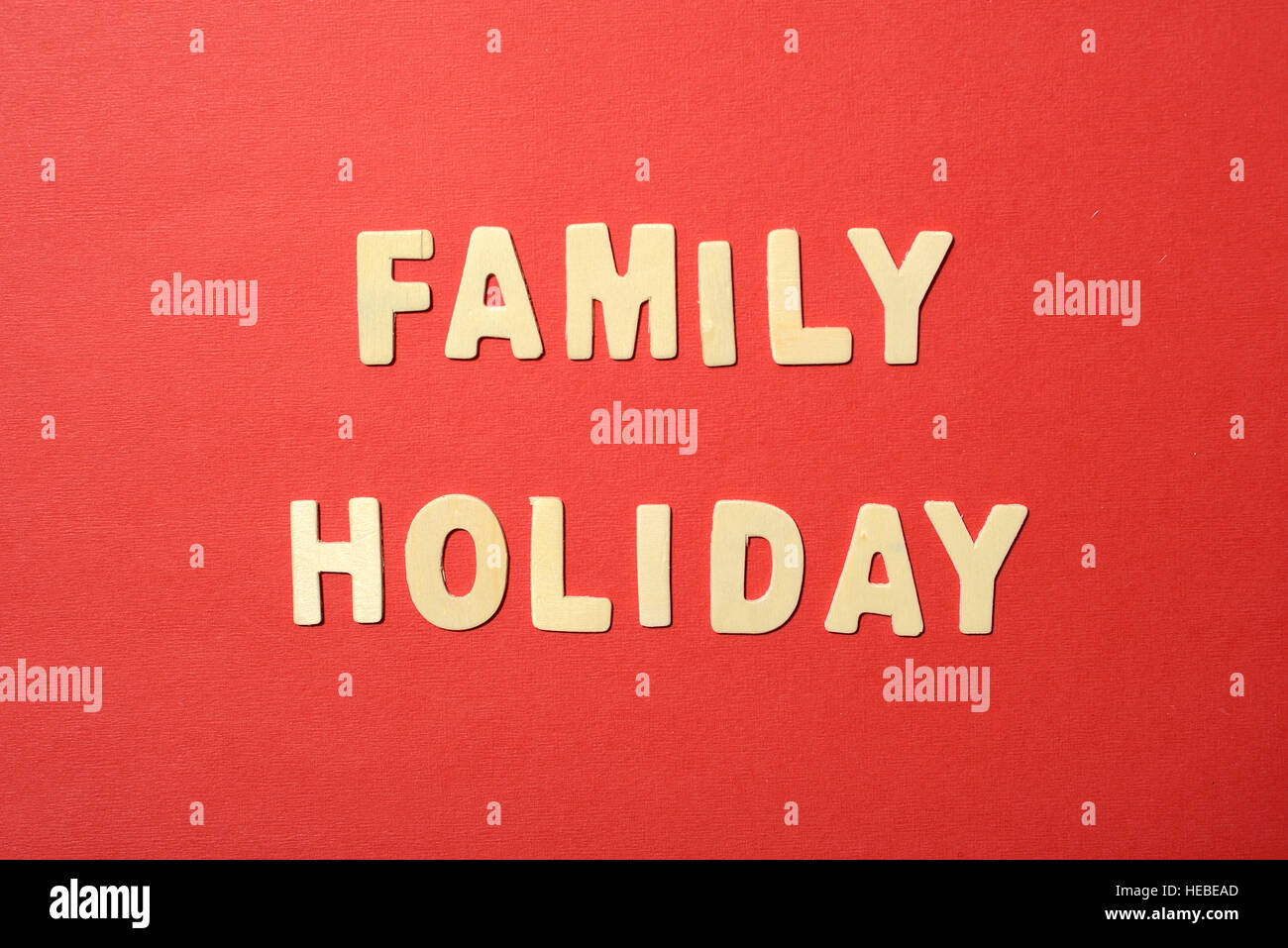 Family Holiday text on red paper background Stock Photo - Alamy