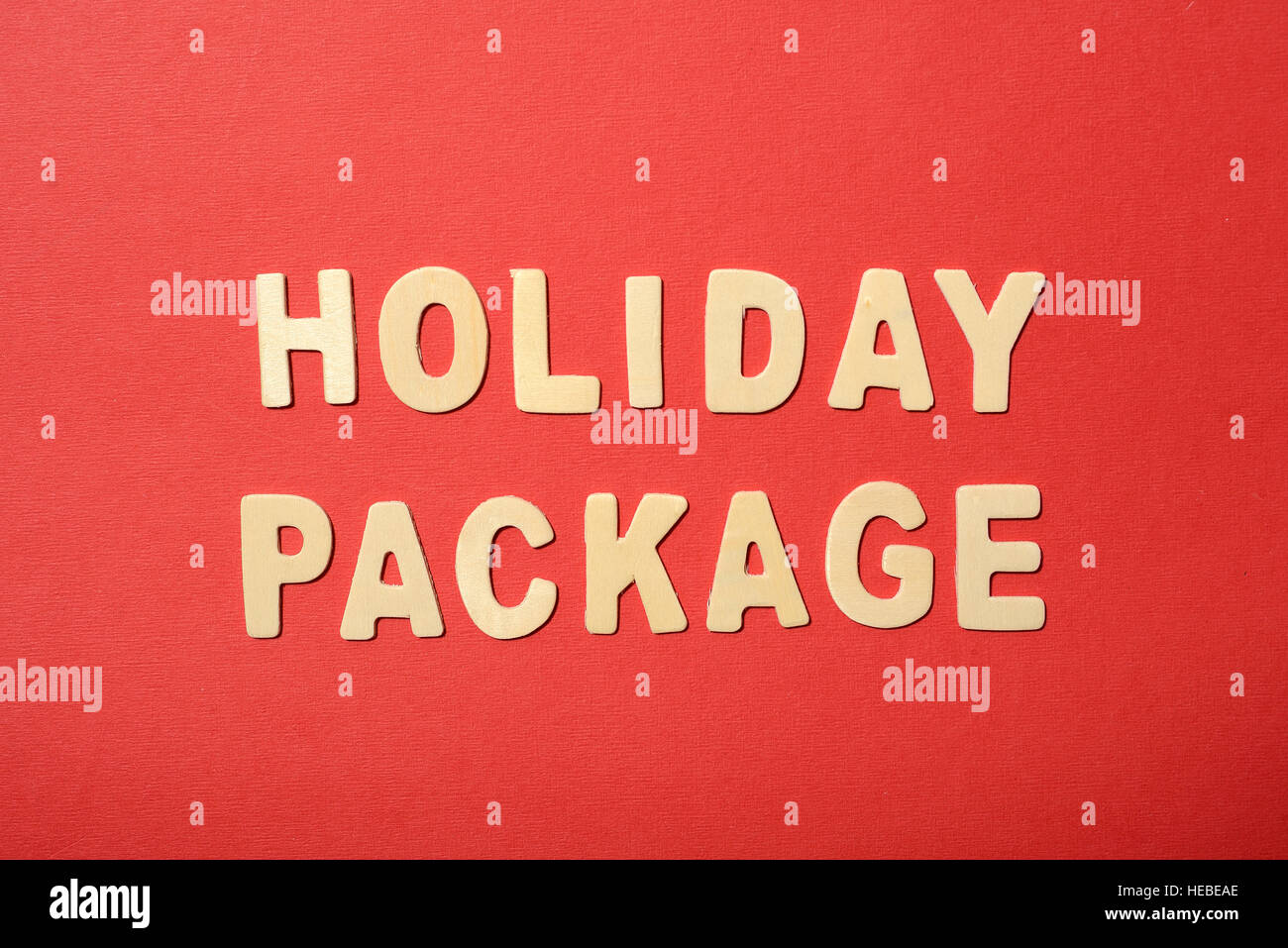 Holiday Package text on red paper background Stock Photo - Alamy