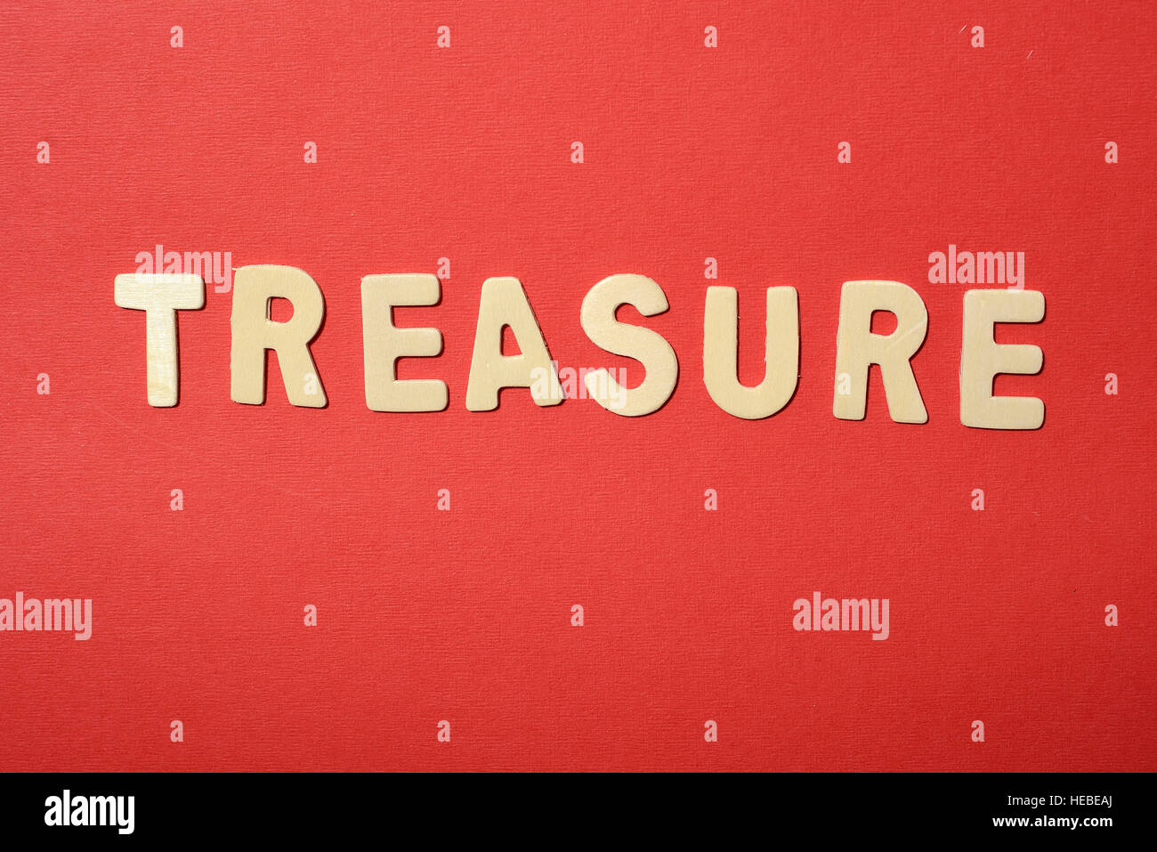 Treasure text on red paper background Stock Photo - Alamy