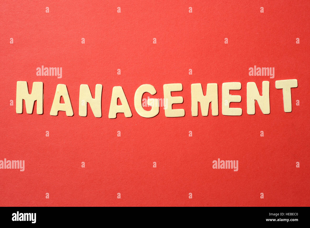 Management text on red paper background Stock Photo - Alamy