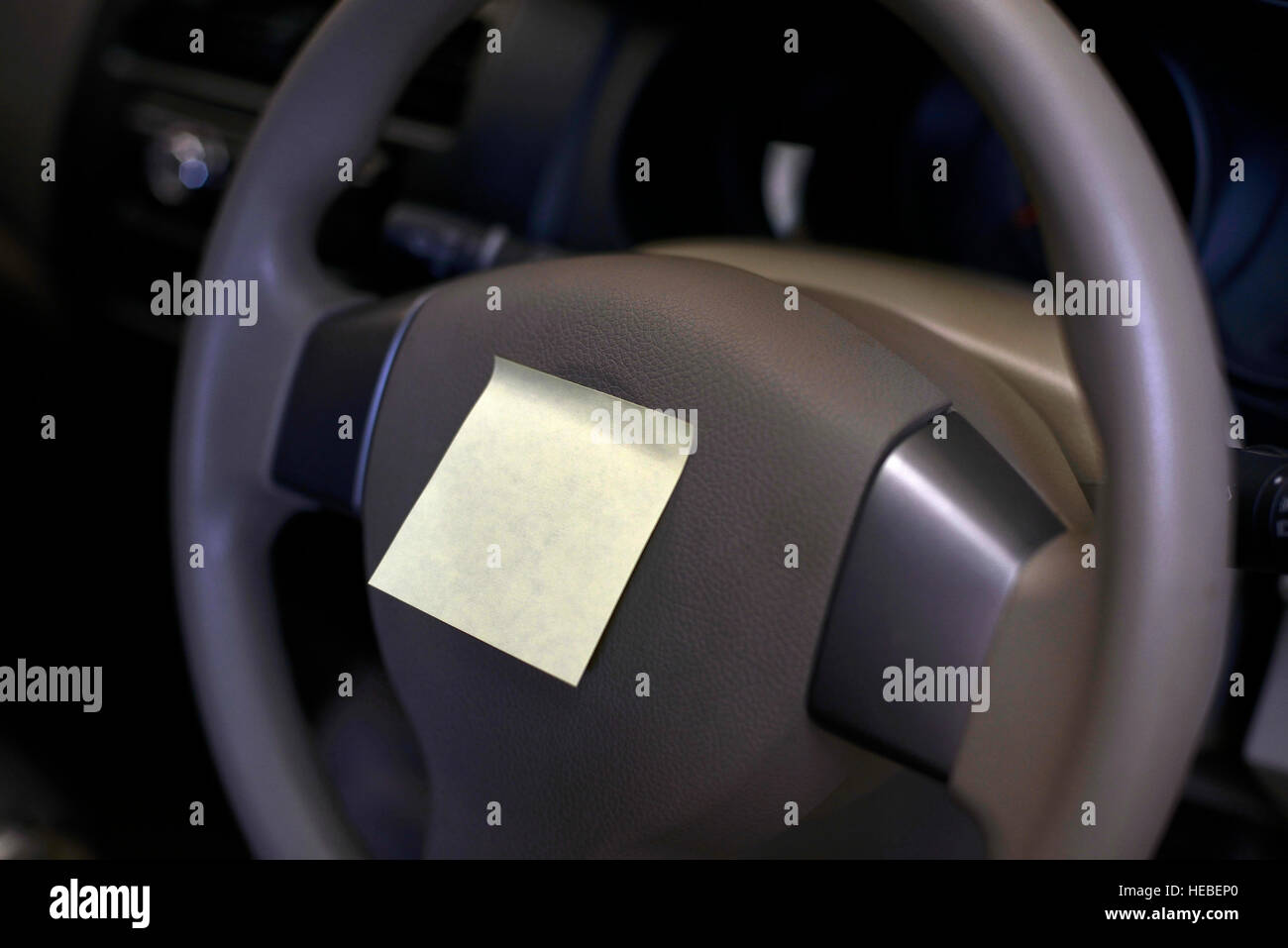 Blank yellow note on steering wheel. You can put your message on the ...