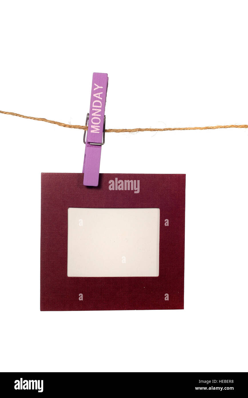 Color frame hanging with monday cloths pin isolated over white ...