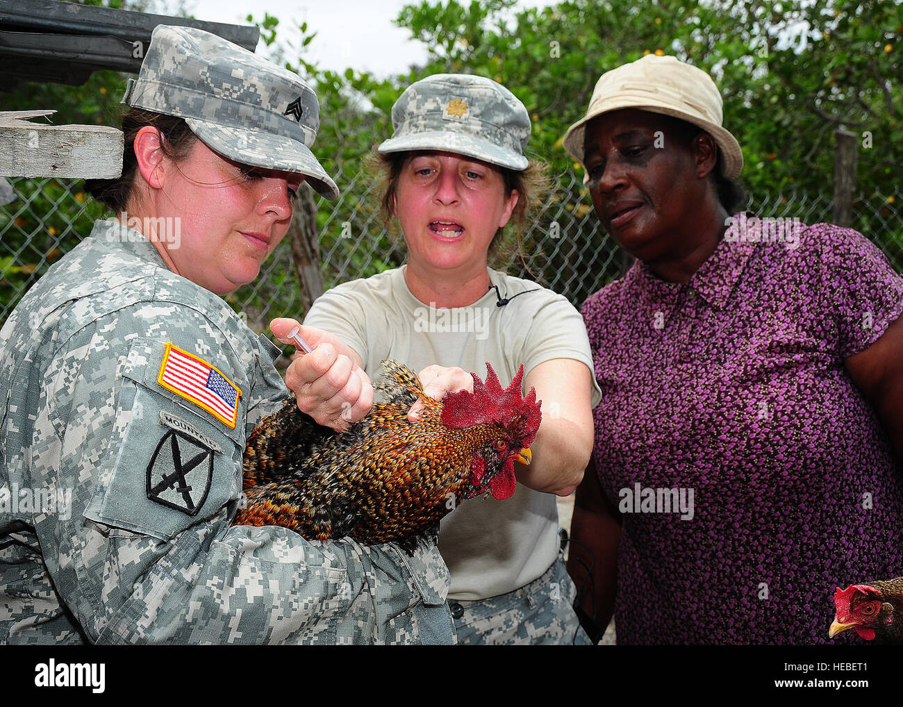 U.S. Army Maj. Erica McNaul, center, veterinarian from the 719th ...