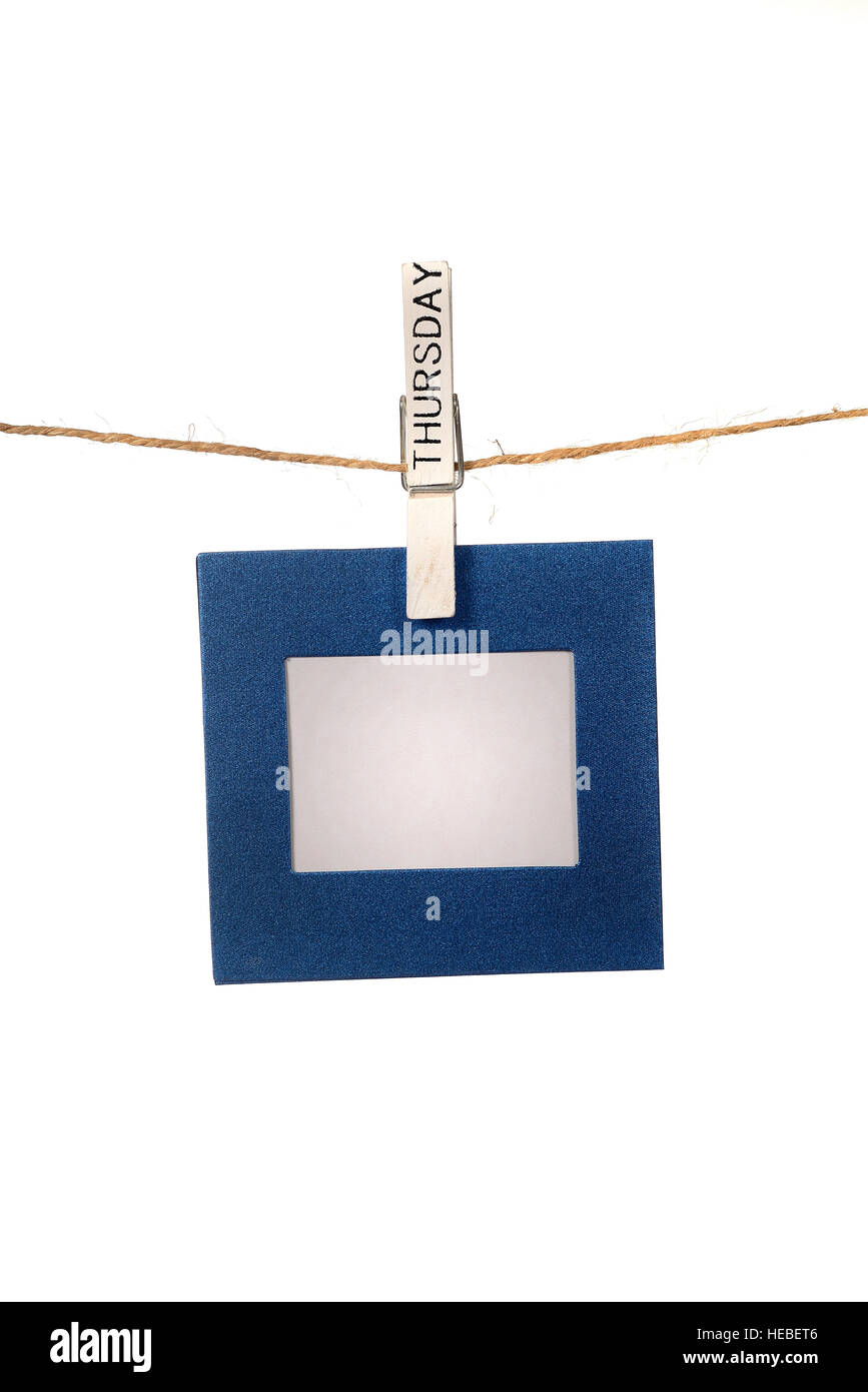 Color frame hanging with thursday cloths pin isolated over white ...
