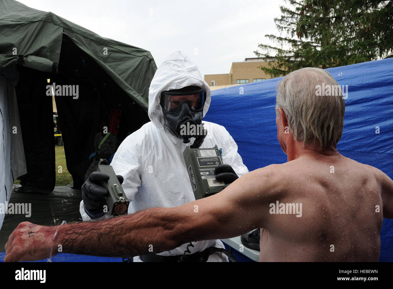 A role player, right, proceeds through a decontamination line with the ...