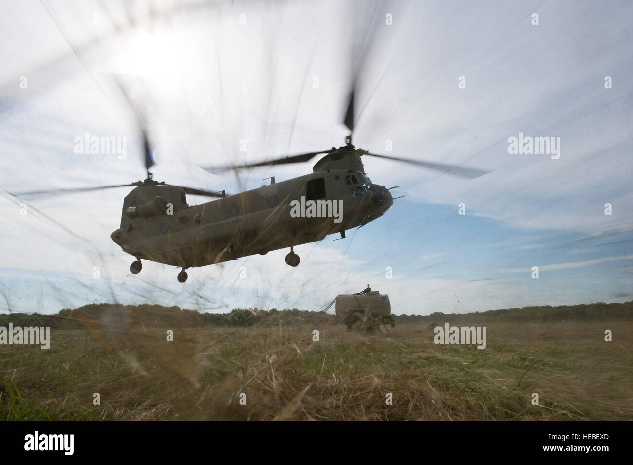 A U.S. Army CH-47 Chinook helicopter approaches a water tank during a ...