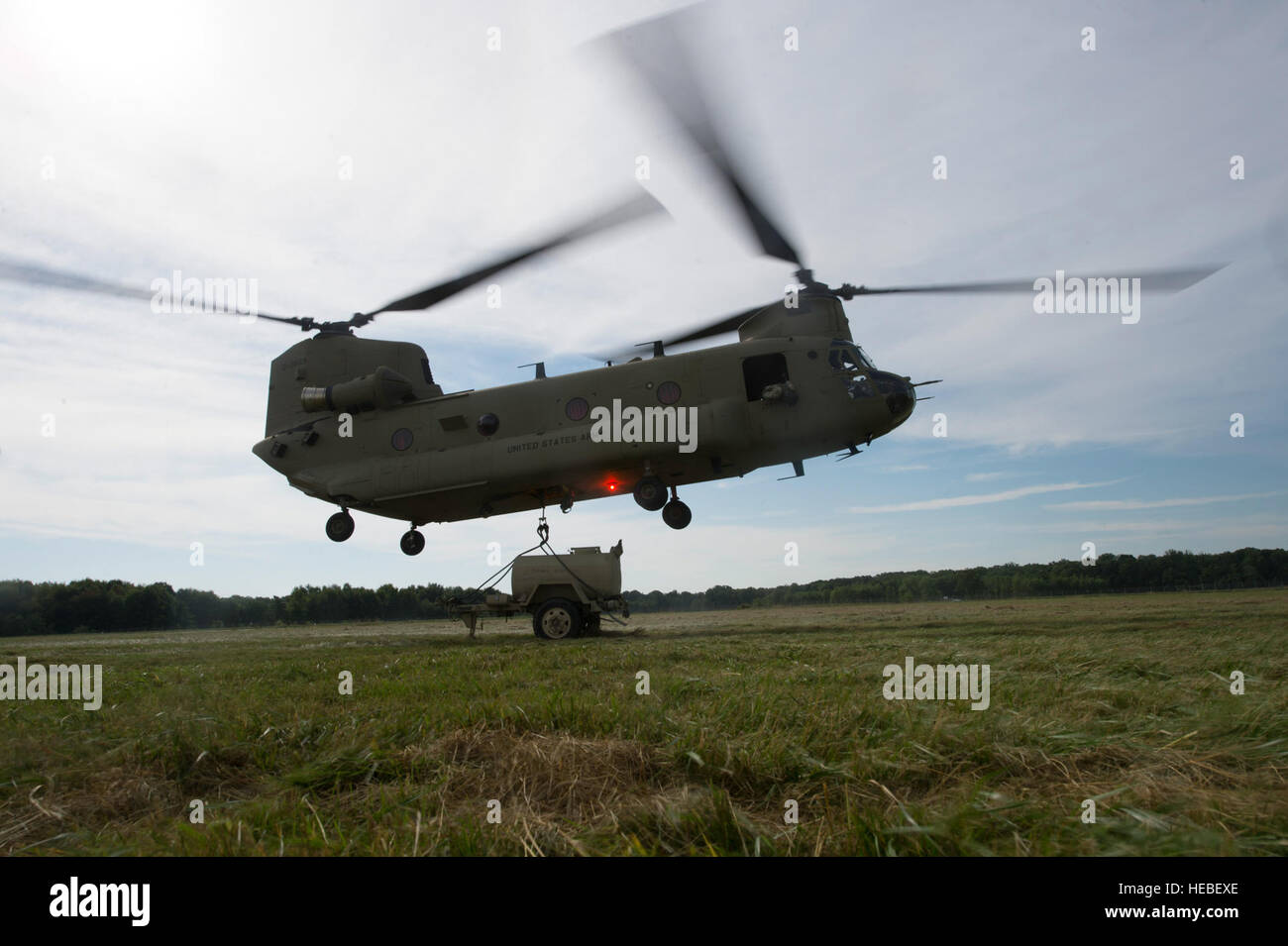 U.S. Army CH-47 Chinook helicopter crew members secure a water tank to ...