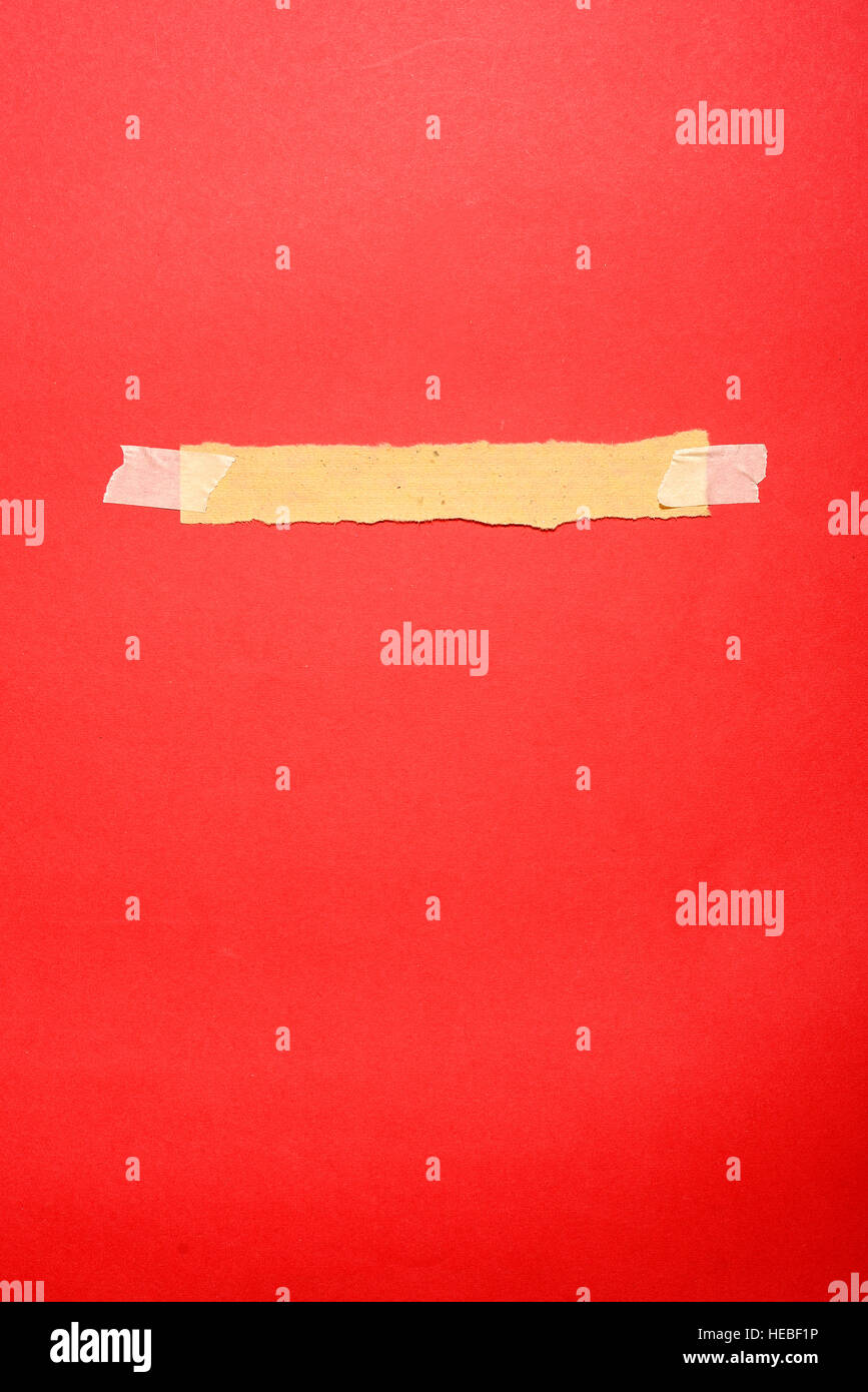 Torn paper with tape on red paper background Stock Photo - Alamy