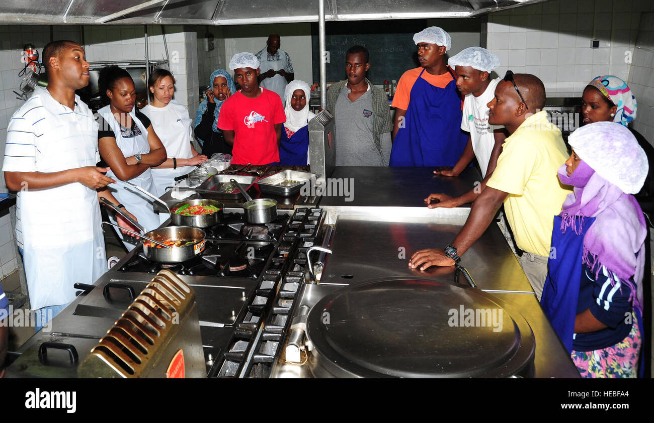 U.S. Navy Petty Officer 1st Class Christopher Radcliffe (left), a ...
