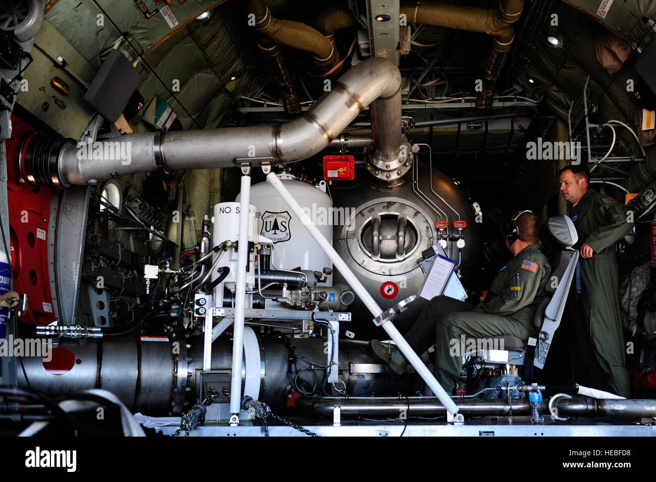 Air Force loadmasters from the 153rd Airlift Wing equip a C-130 ...